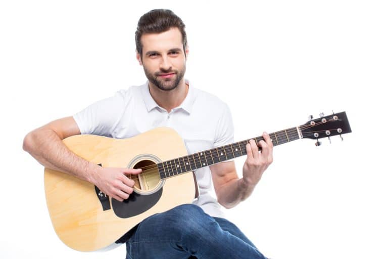 How to Hold a Guitar With Proper Posture & Positioning - Music Grotto